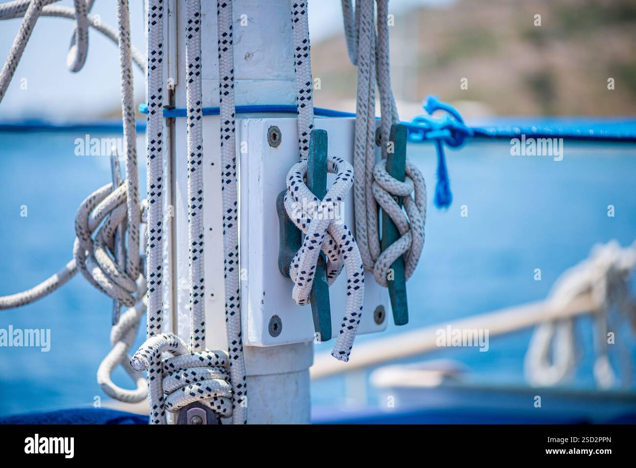 A close-up view of strong, weathered ropes tightly secured around a ...