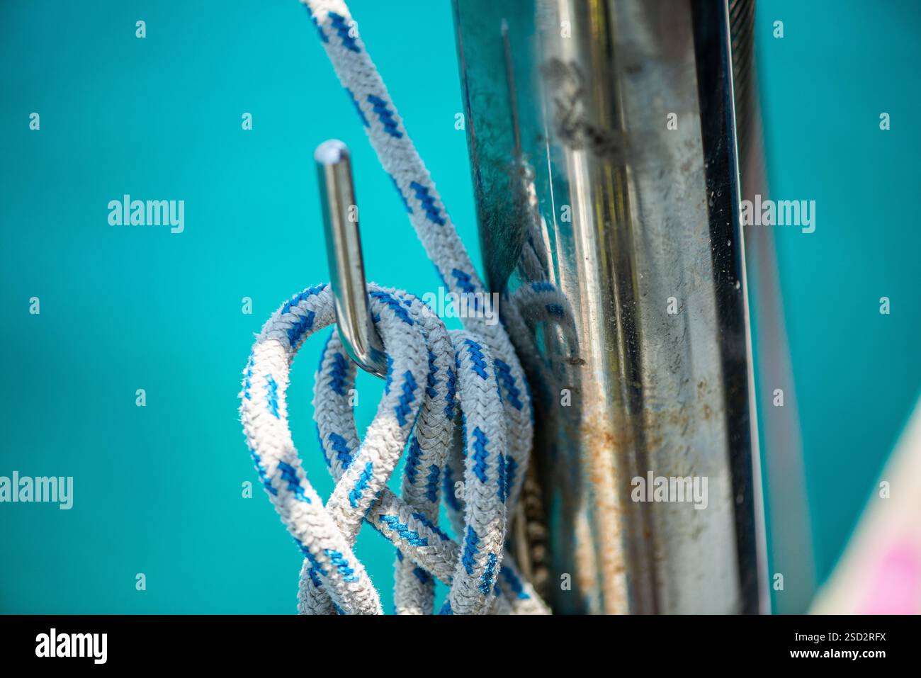 A close-up view of strong, weathered ropes tightly secured around a ...