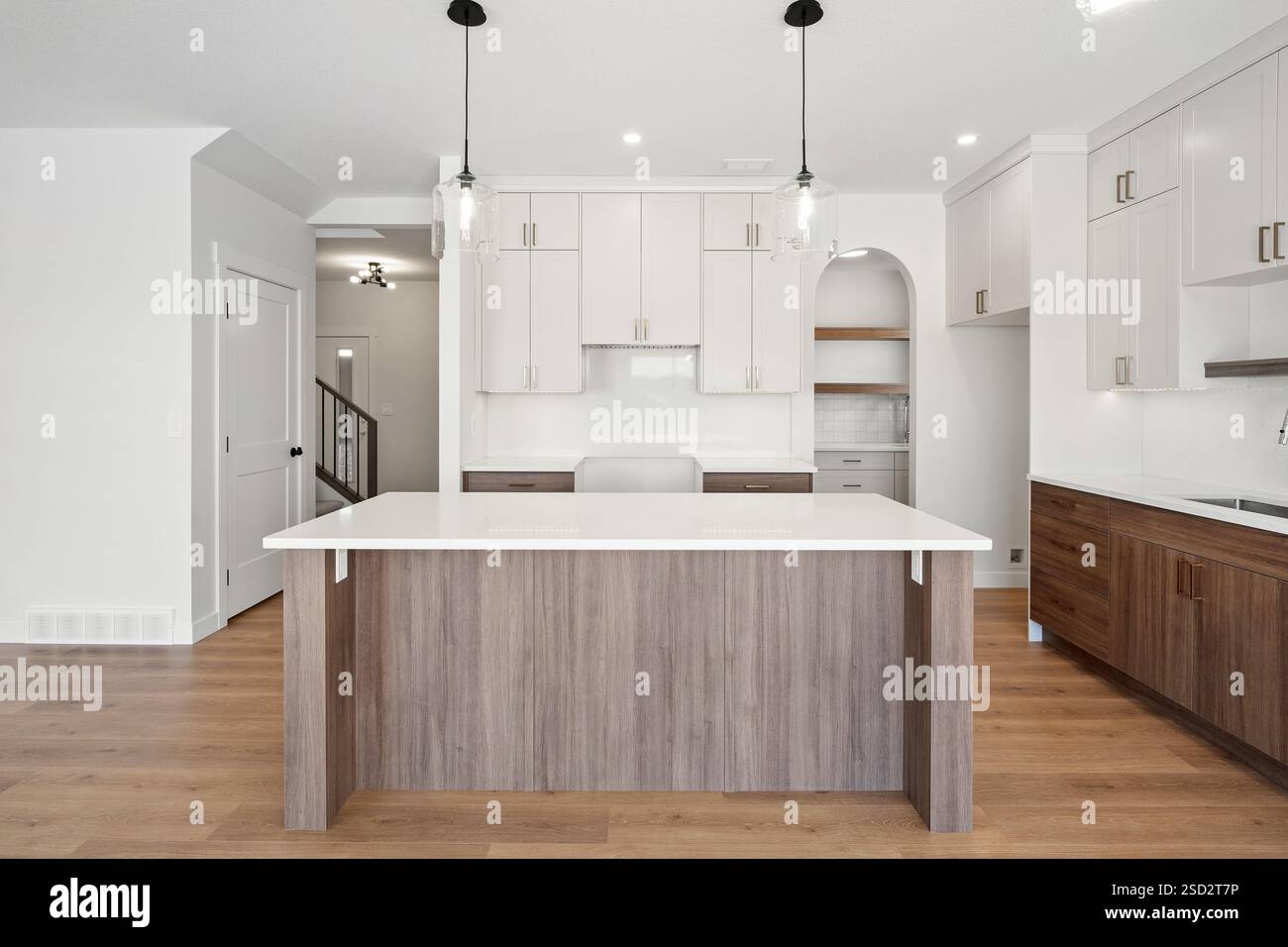 Kitchen with a white counter and wooden cabinets. The counter is empty ...