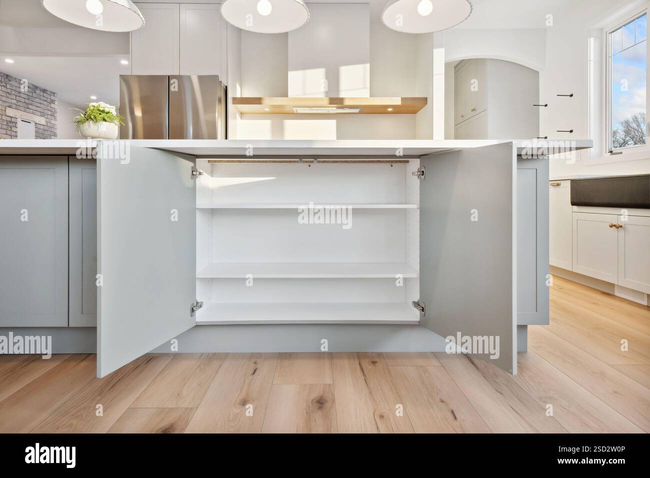 The kitchen is very clean and well-organized. The cabinets are open ...