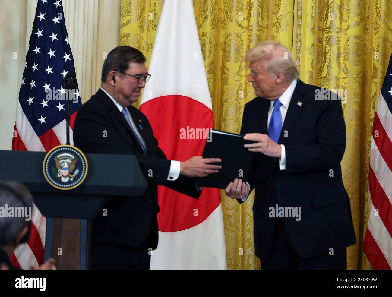 Japanese Prime Minister Shigeru Ishiba (L) and U.S. President Donald ...