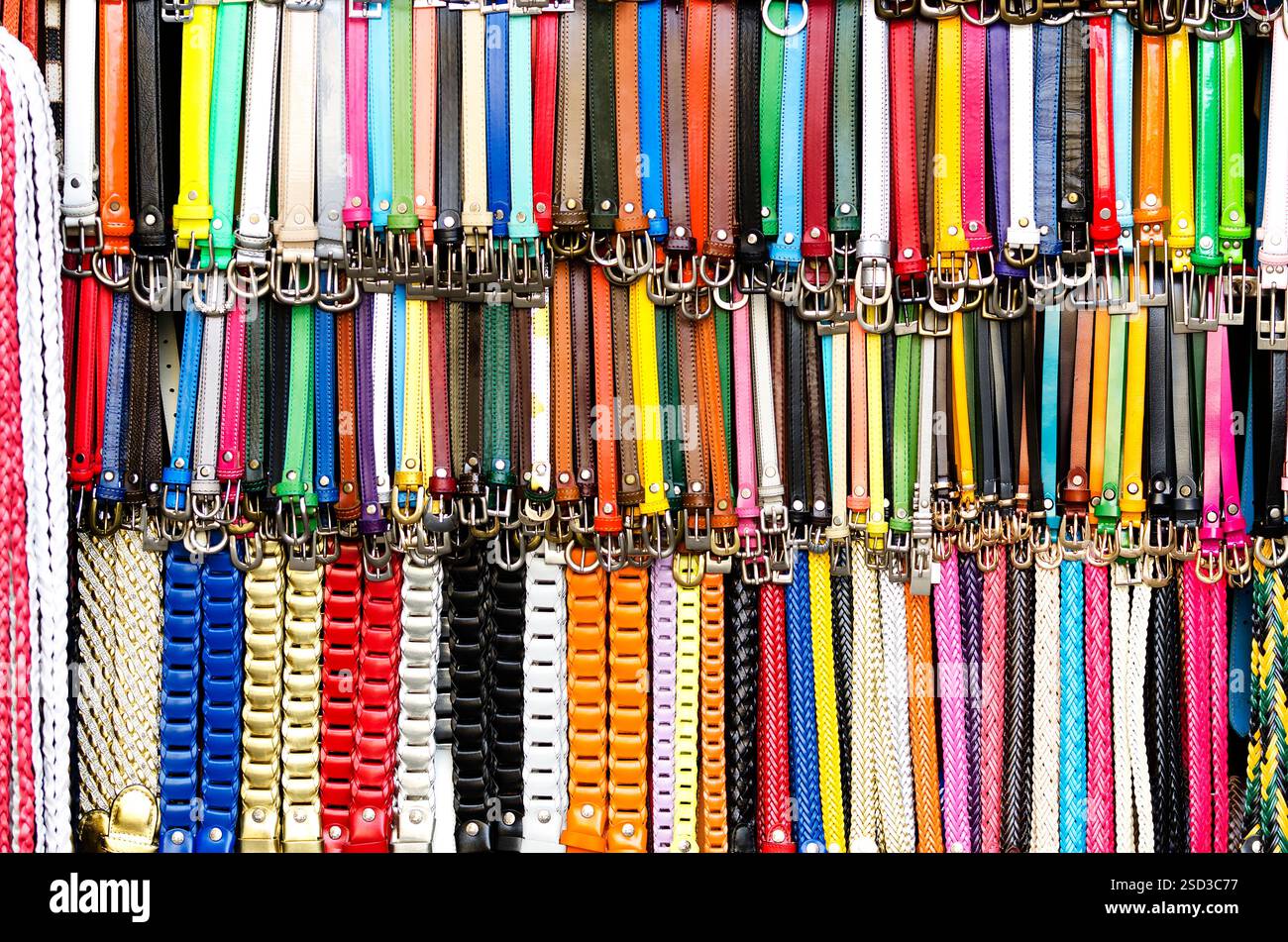 colorful belts hanging on the wall in the store Stock Photo - Alamy