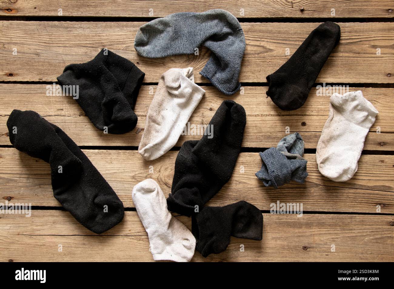 Lots of different worn socks scattered on the floor of the house, worn ...