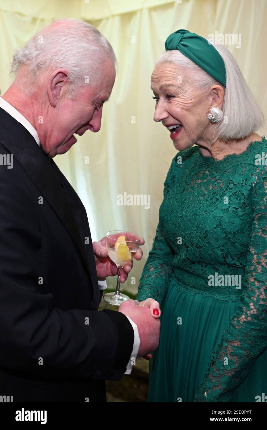 King Charles III greets Helen Mirren during a dinner in celebration of ...