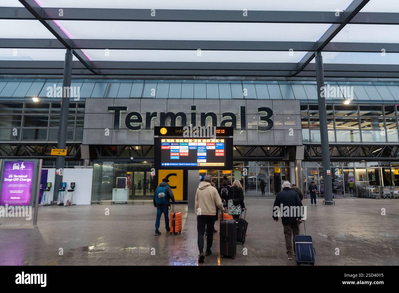 Passengers arriving at Terminal 3 of London Heathrow Airport, UK. Wet ...