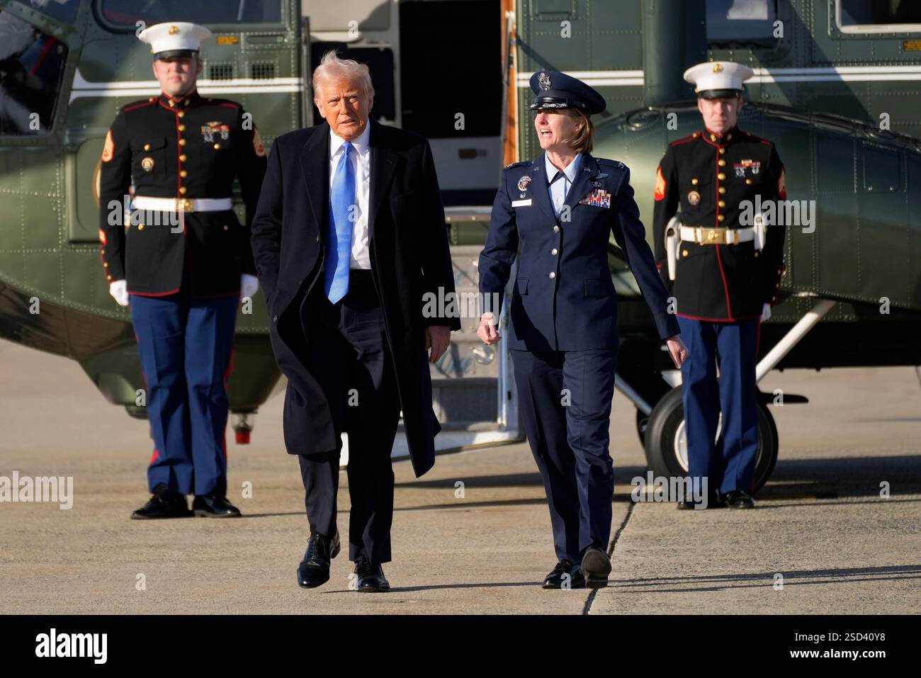 President Donald Trump walks to board Air Force One with Col. Angela ...