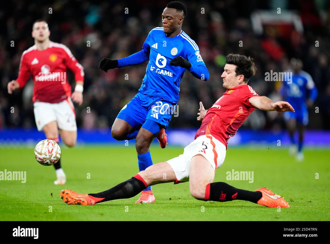 Manchester United's Harry Maguire (right) tackles Leicester City's ...