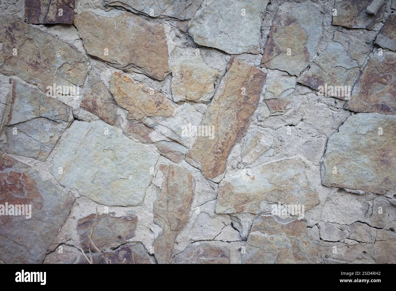 Close-up view of a natural stone wall featuring various shades and ...