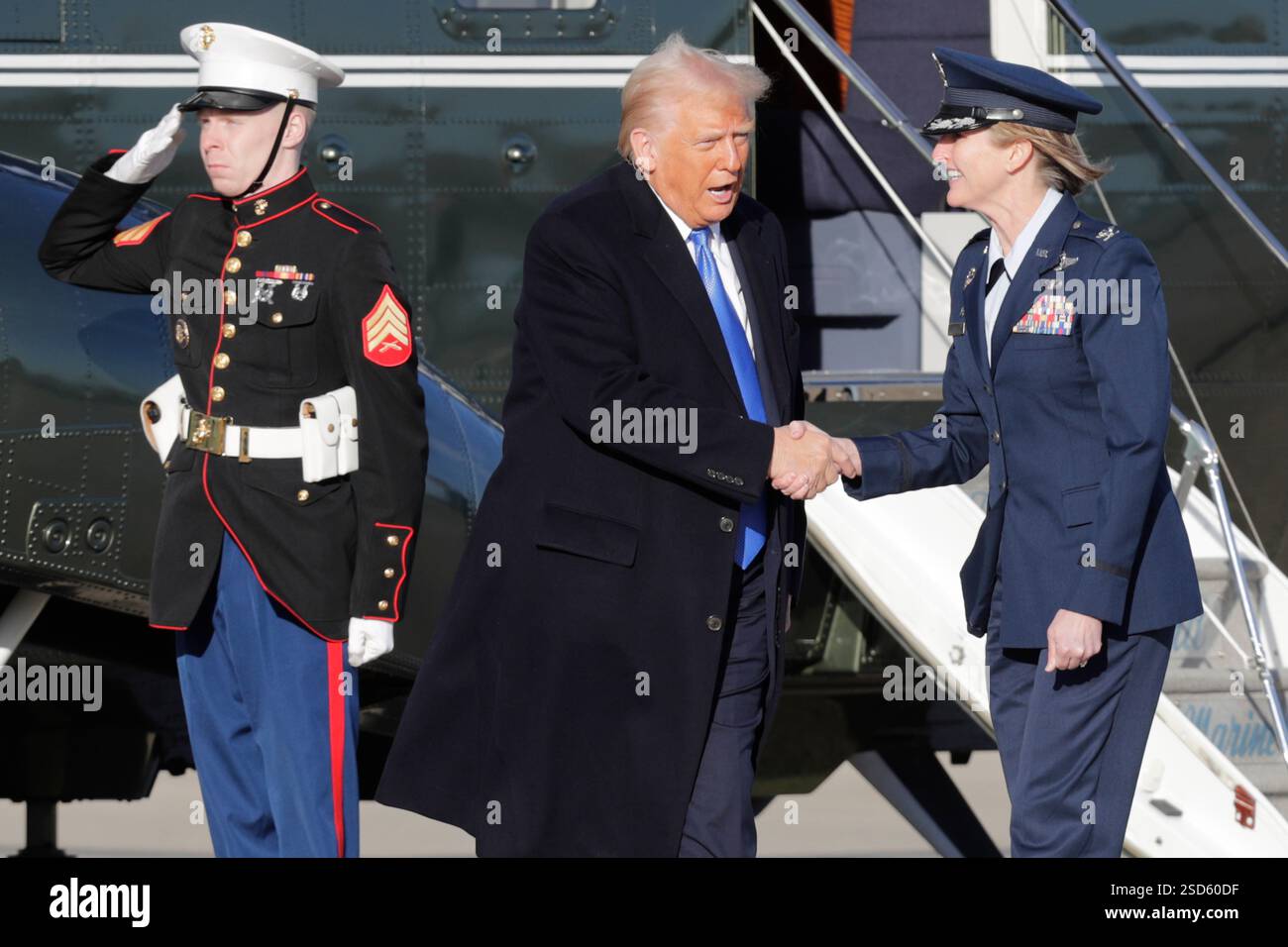 President Donald Trump, center, is greeted by Col. Angela F. Ochoa ...