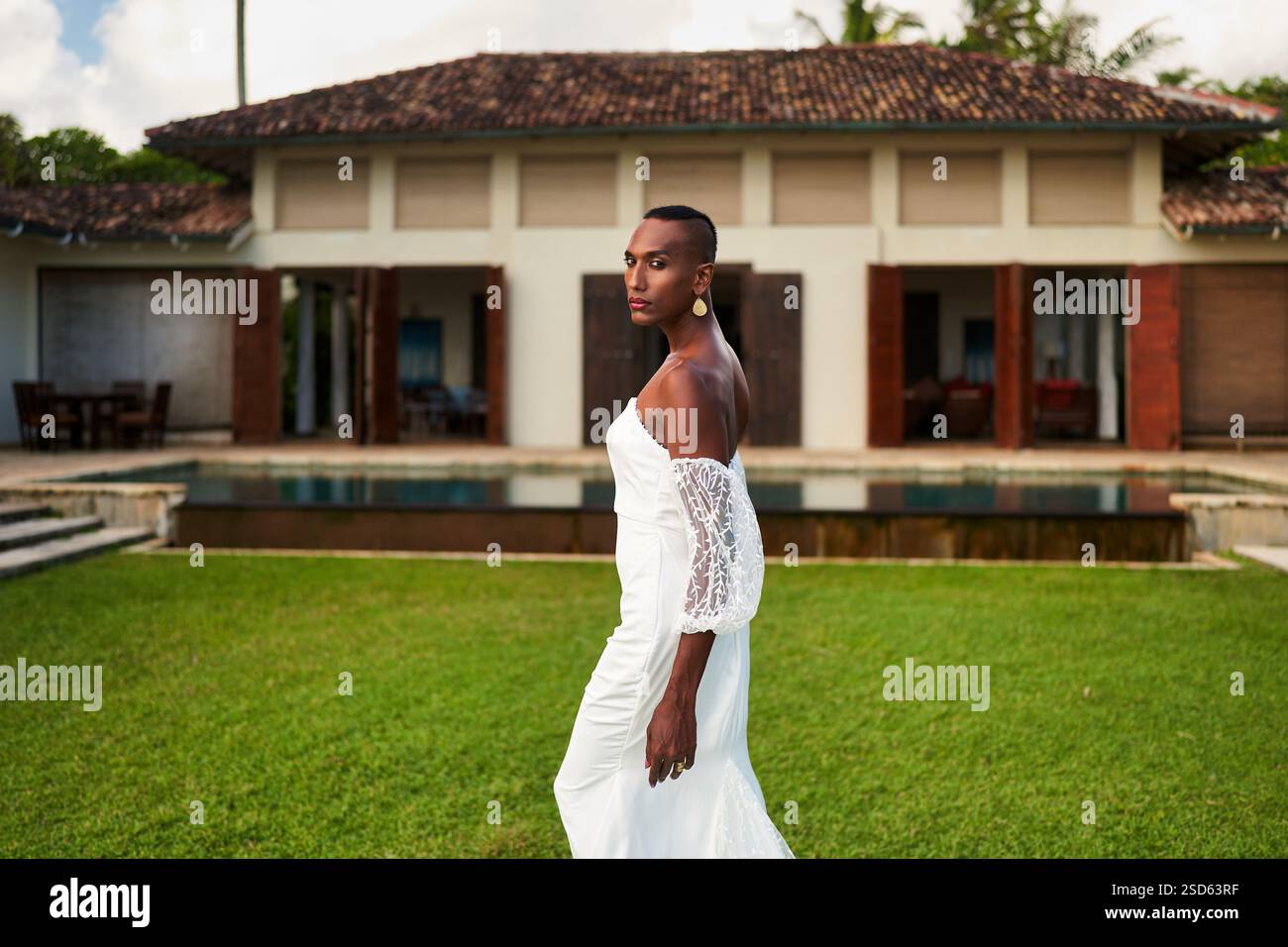 Black person in elegant white dress, villa garden. Comfortable fashion ...