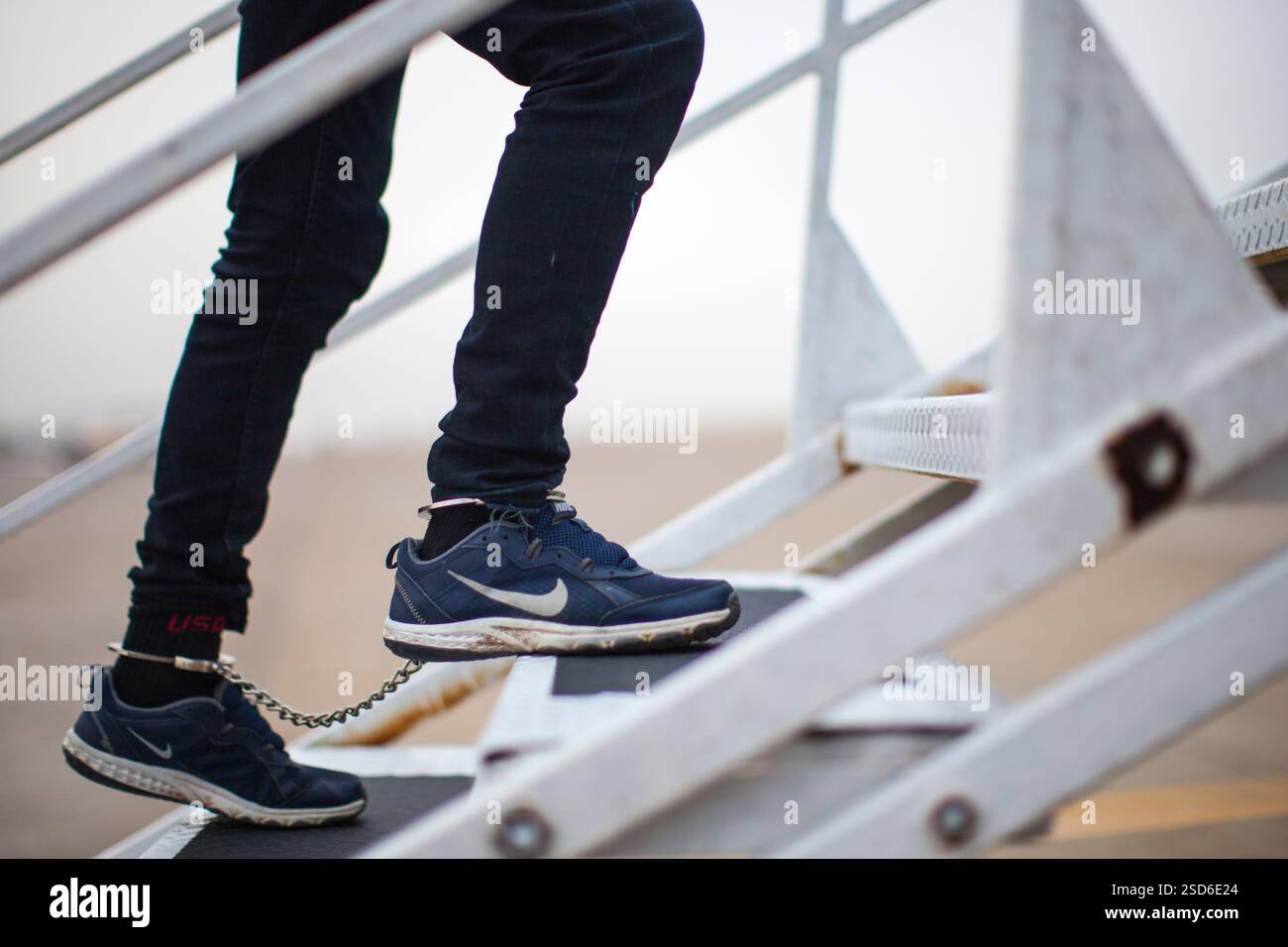 An illegal alien board a plane for a removal flight Stock Photo - Alamy