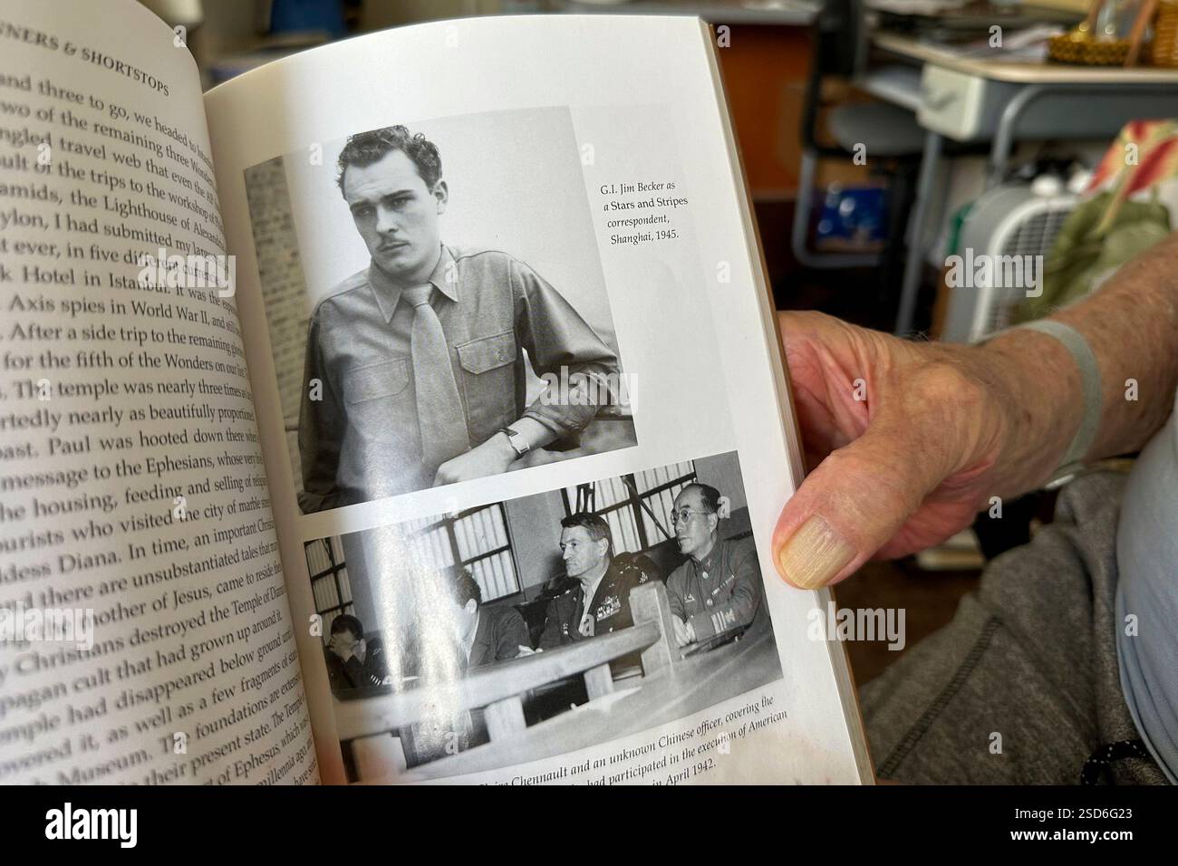 Jim Becker, a former Associated Press journalist, holds a book showing ...