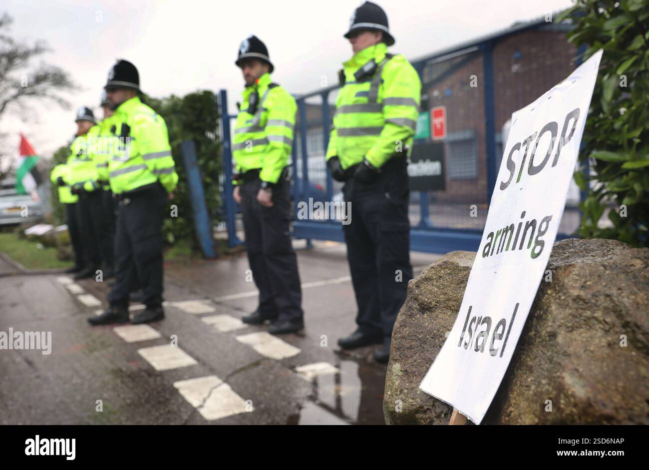 Police officers form a cordon outside the UAV drone factory by a sign ...