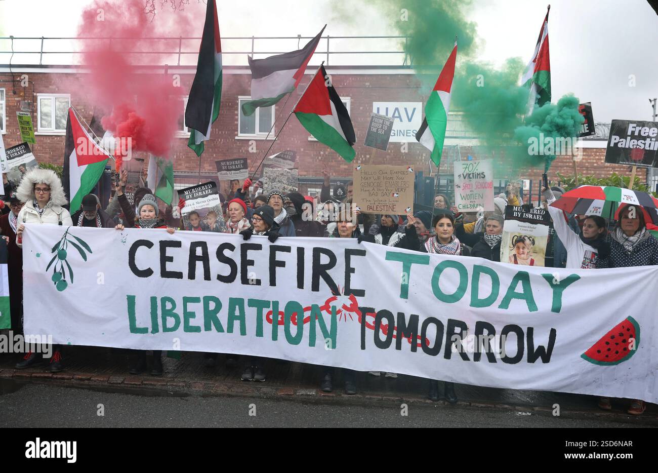 Protesters gather behind a banner saying ‘Ceasefire Today Liberation ...