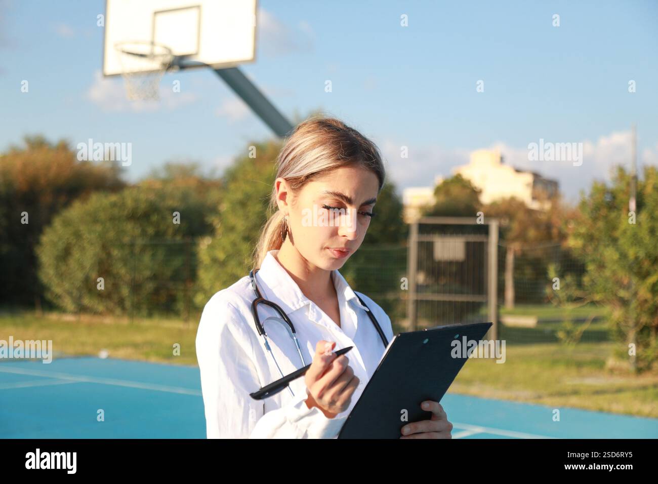 Focused Doctor Taking Notes in Open Air Stock Photo - Alamy