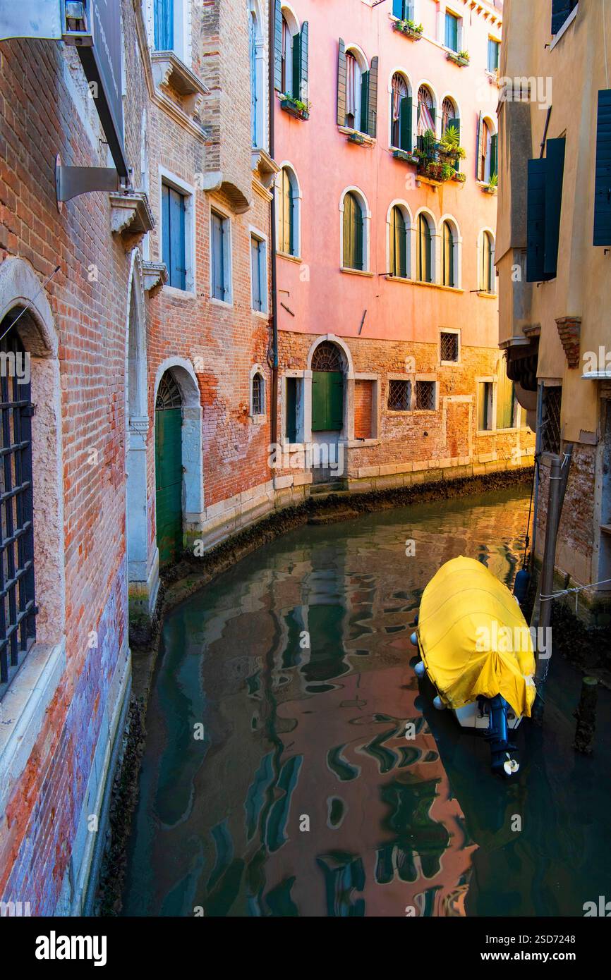 Idyllic canals with boat between houses in the old town centre, Italy ...