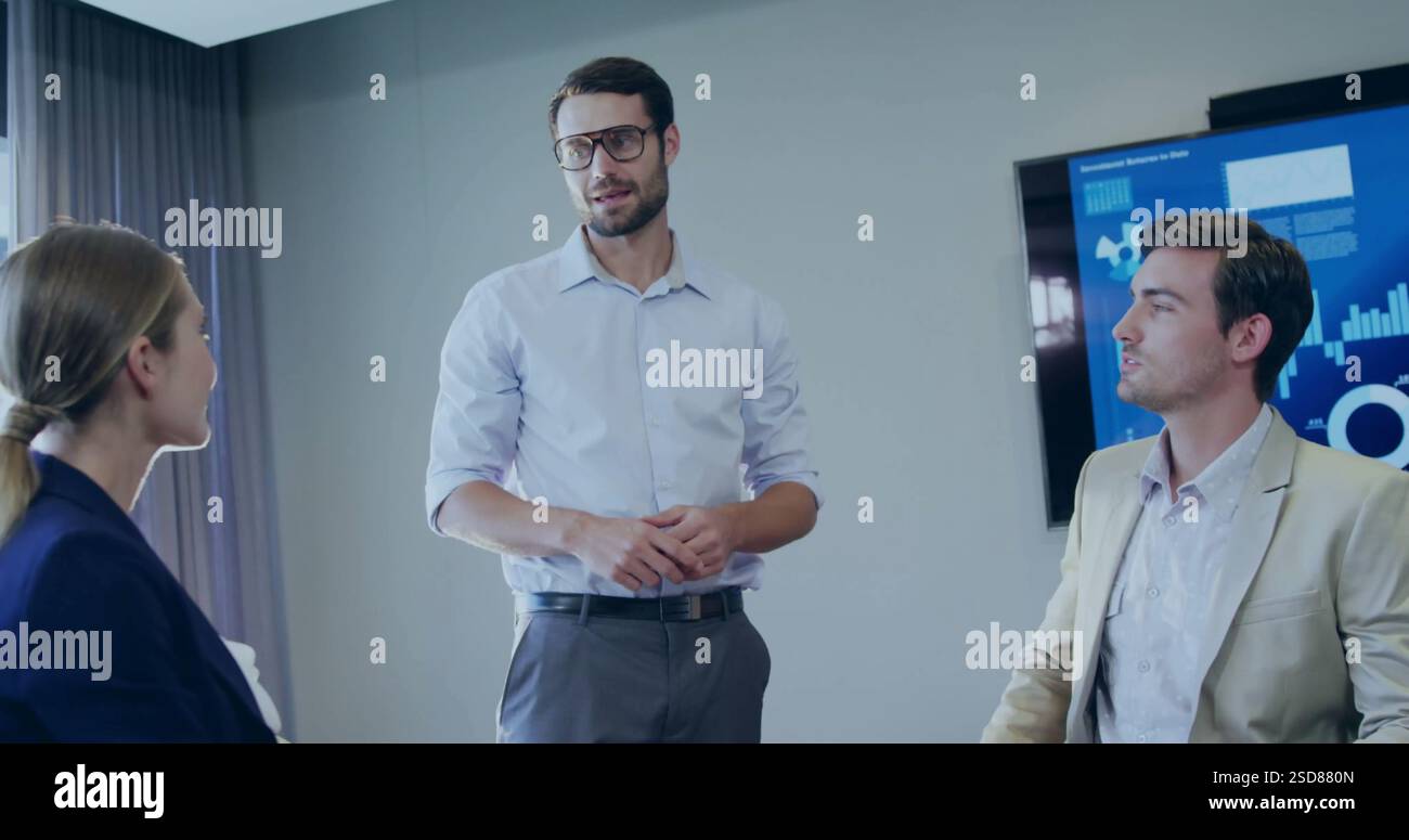 Business meeting with colleagues discussing data on screen in modern ...