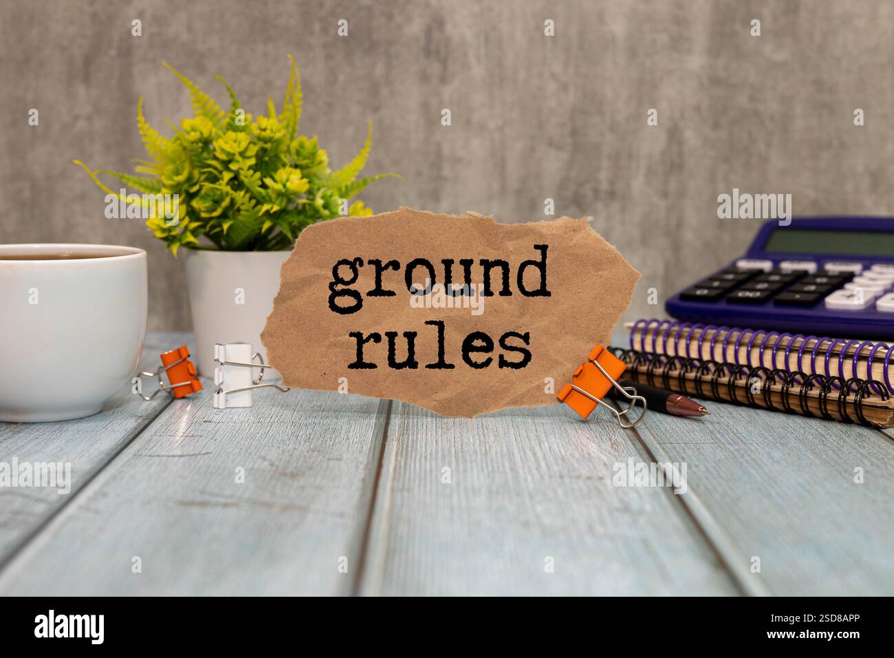Ground Rules text on sticky note with alarm clock on cork paper ...