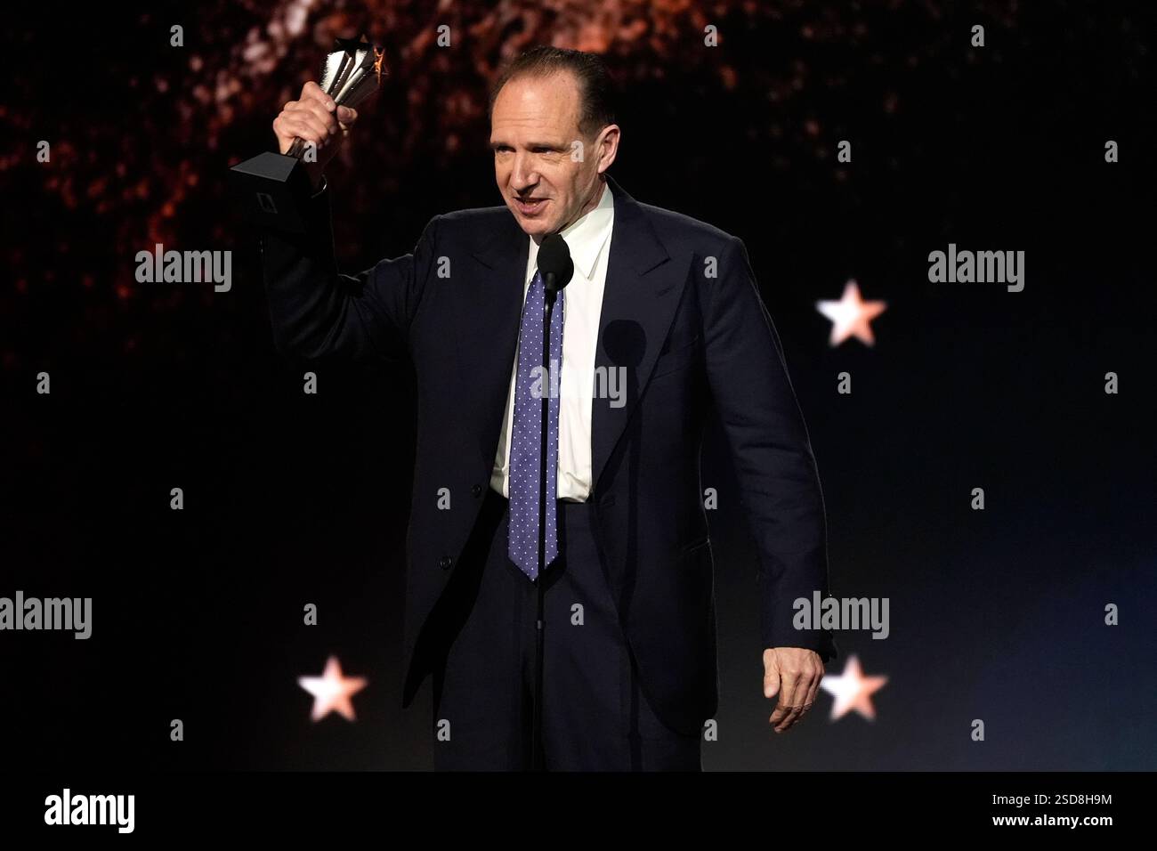 Ralph Fiennes accepts the award for best acting ensemble for "Conclave ...