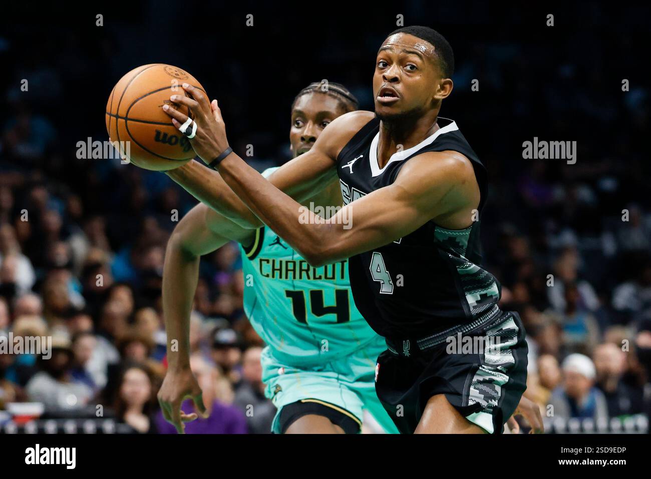 San Antonio Spurs guard De'Aaron Fox (4) looks to pass the ball ahead ...