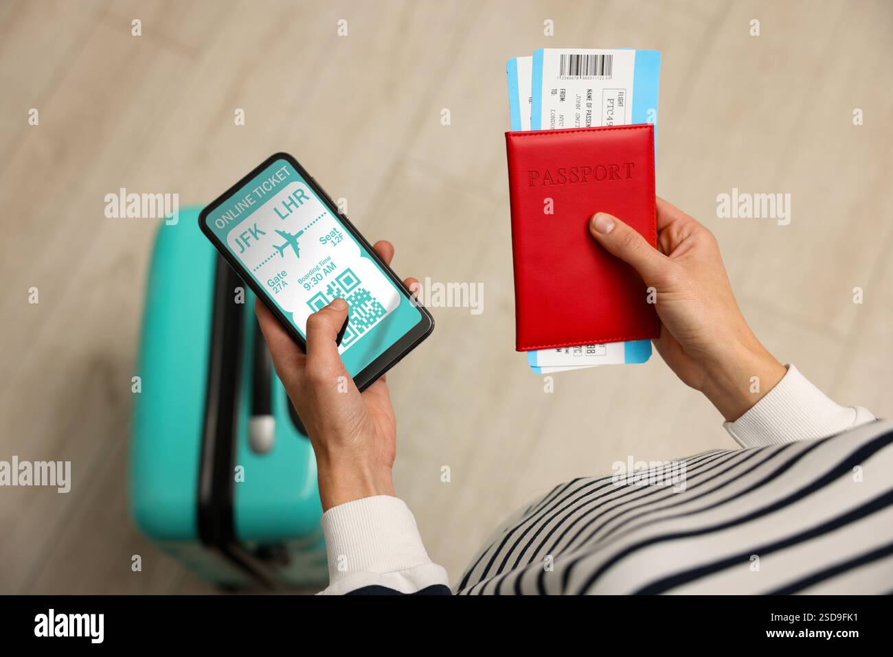 Tourist with passport, flight tickets and mobile phone indoors, above ...