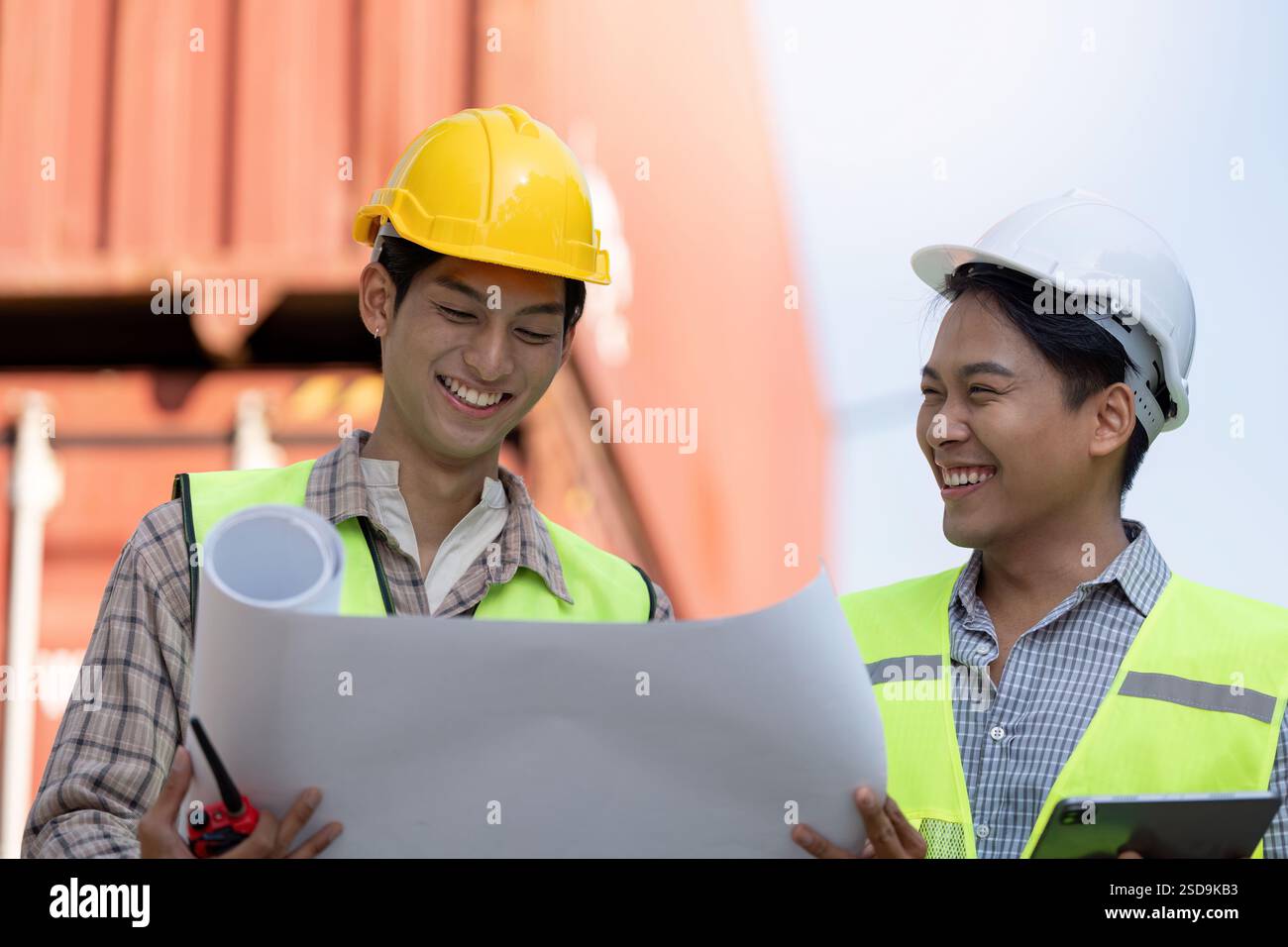 Engineers collaborating on logistics plans at construction site urban ...