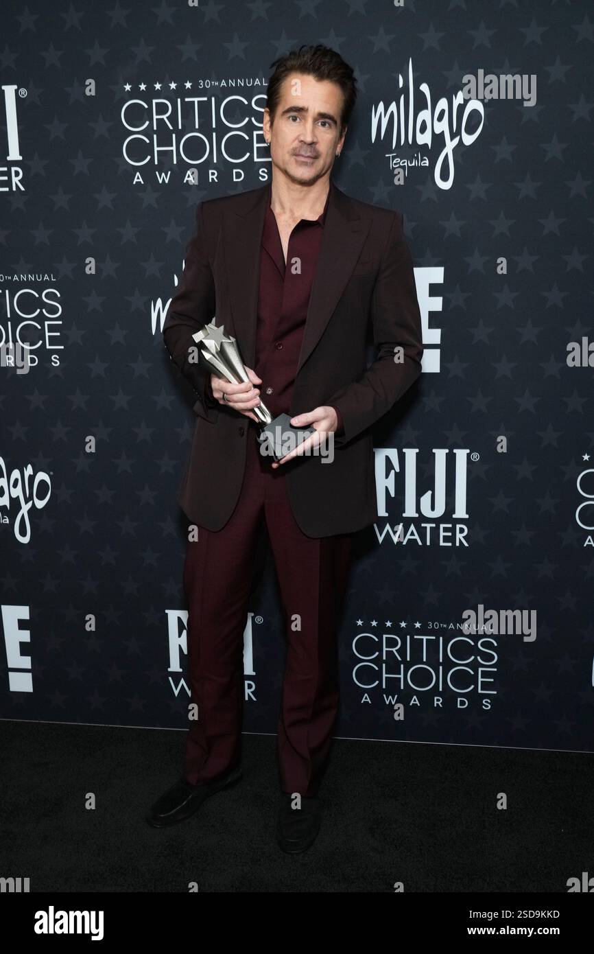 Colin Farrell poses in the press room with the award for best actor in ...