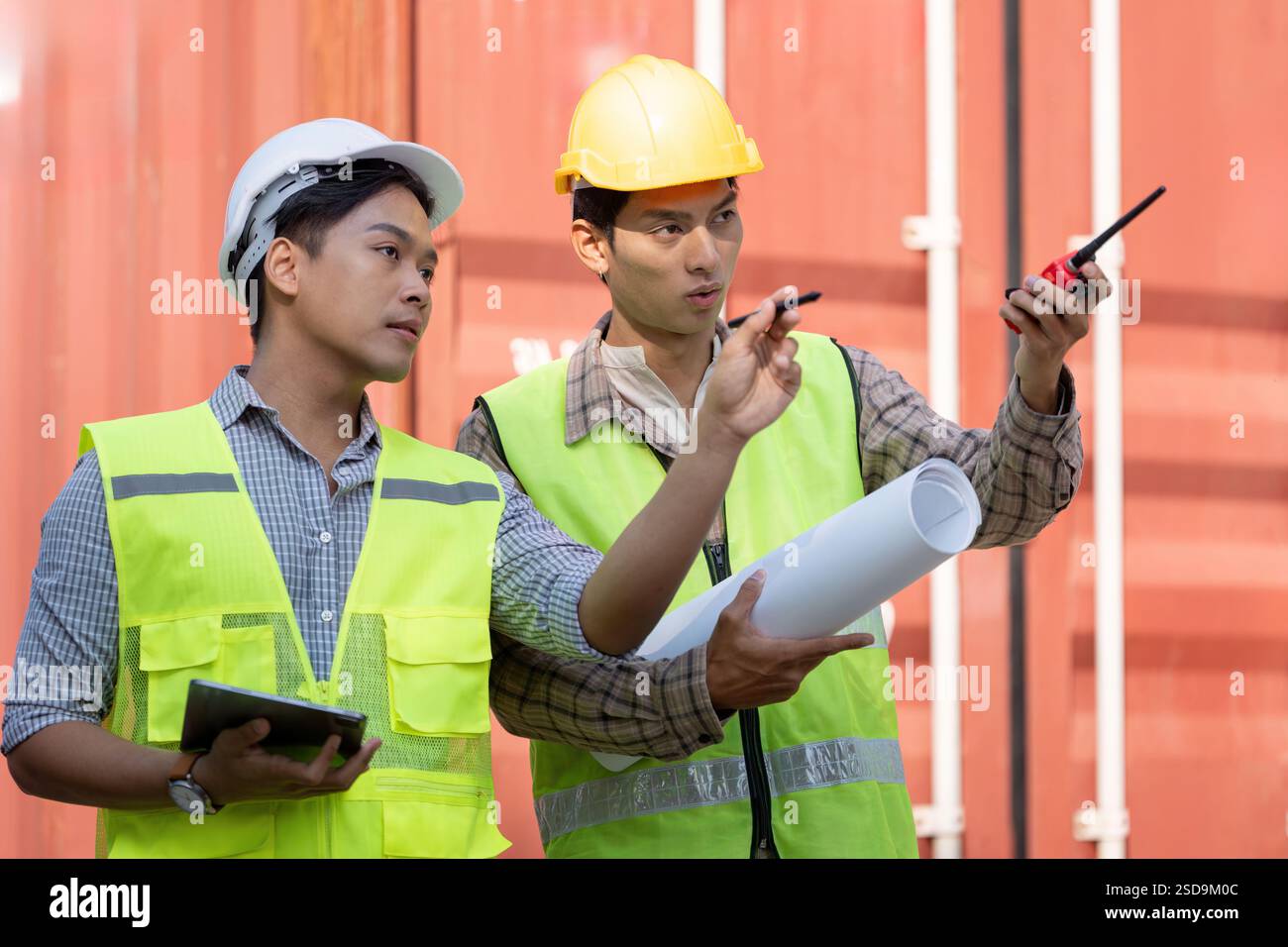 Logistics engineers collaborate on container management warehouse ...