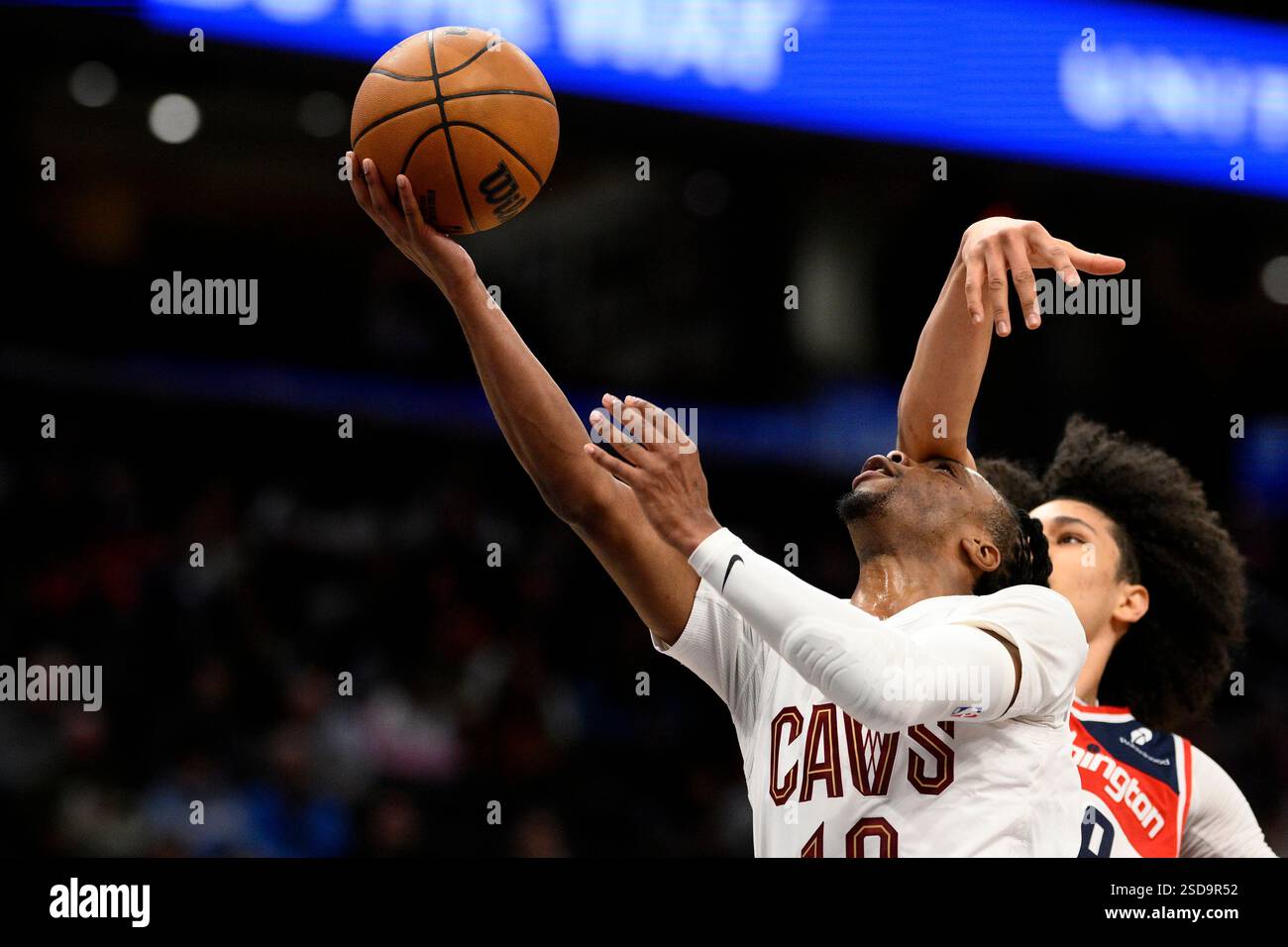 Washington Wizards forward Kyshawn George, right, fouls Cleveland ...