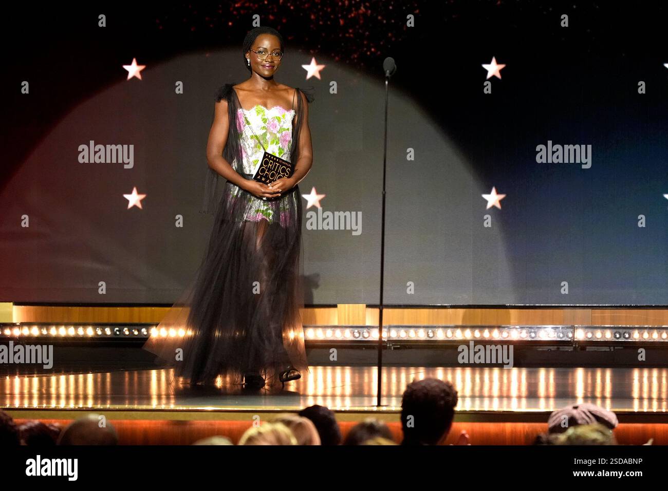 Lupita Nyong'o presents the award for best supporting actor during the ...