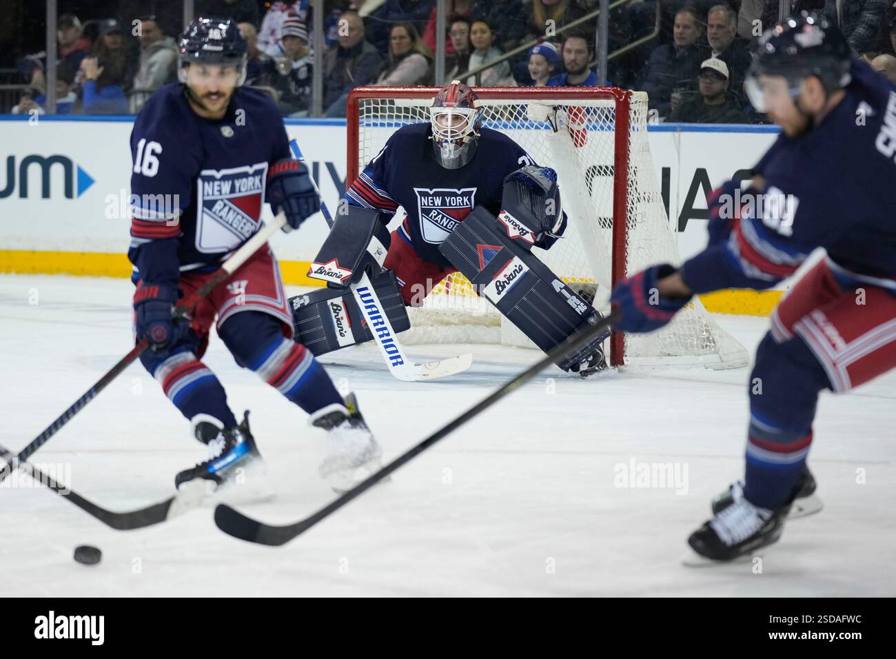 New York Rangers goaltender Igor Shesterkin, center, tend goal during ...