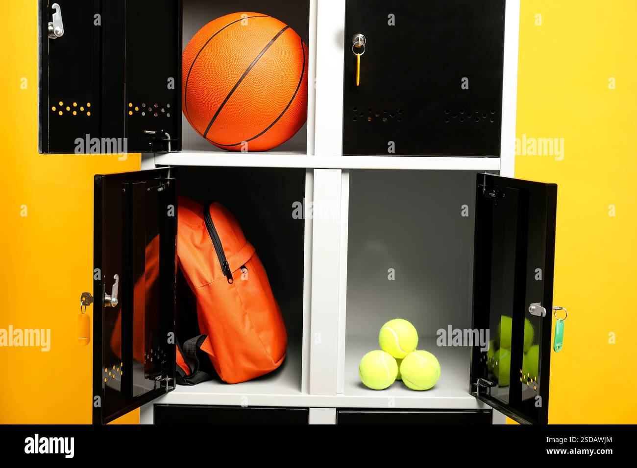 Open lockers with sport equipment on orange background Stock Photo - Alamy