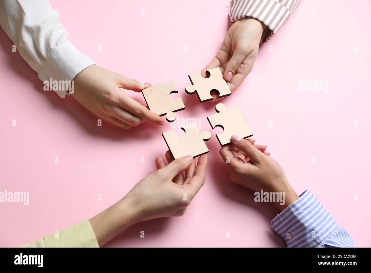 Business strategy and teamwork concept. Group of businesspeople putting ...