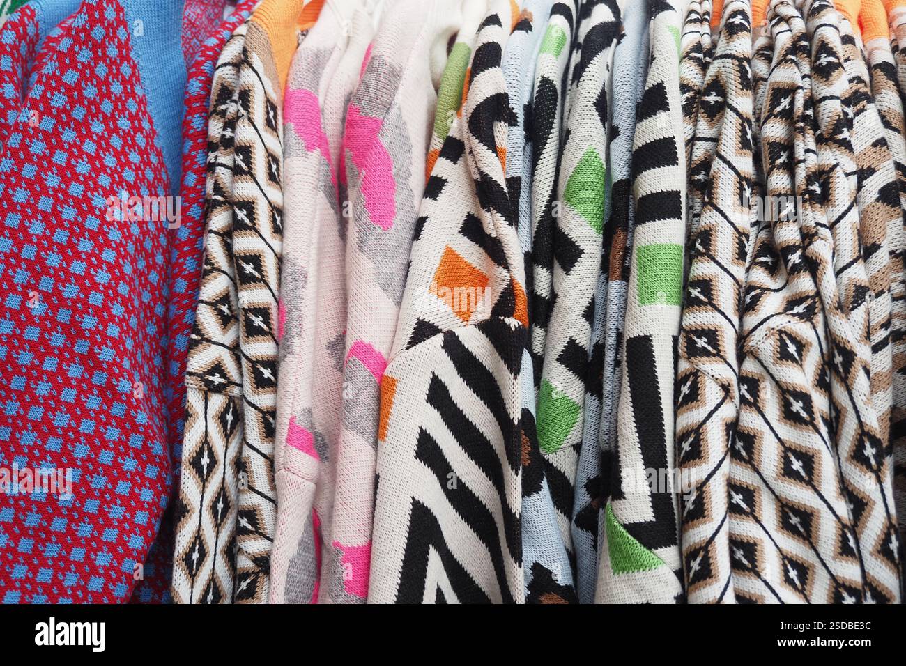 Colorful knitted sweaters displayed at a vibrant market stall Stock ...