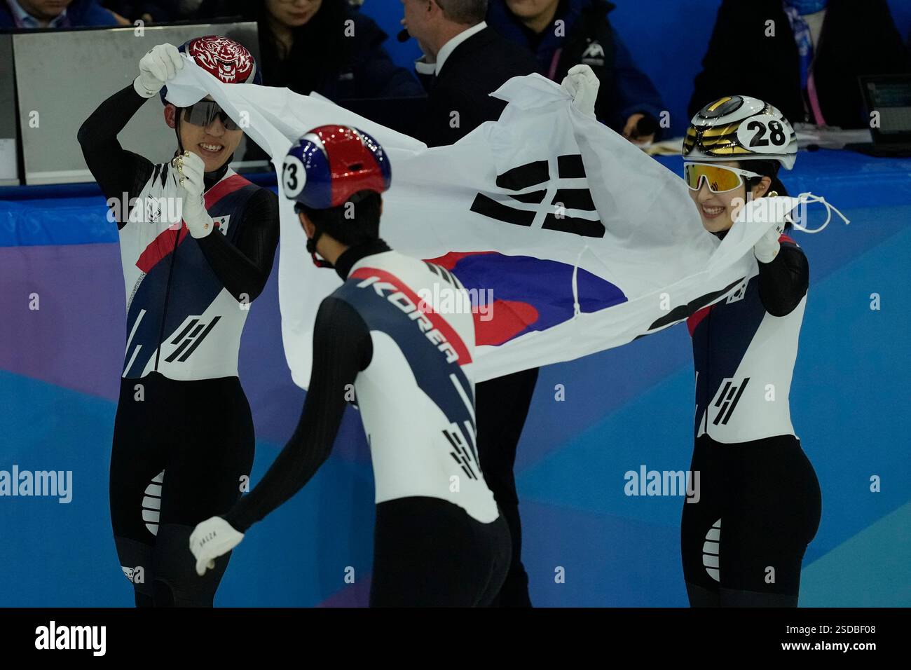 South Korea team carries their national flag after winning the mixed team 2000m relay finals of ...