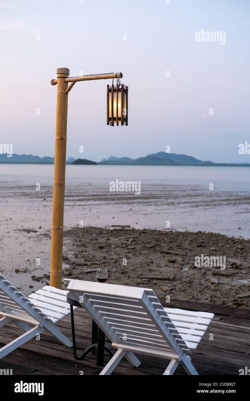 Outdoor seating on the terrace, with bamboo lamp post. With view of the ...