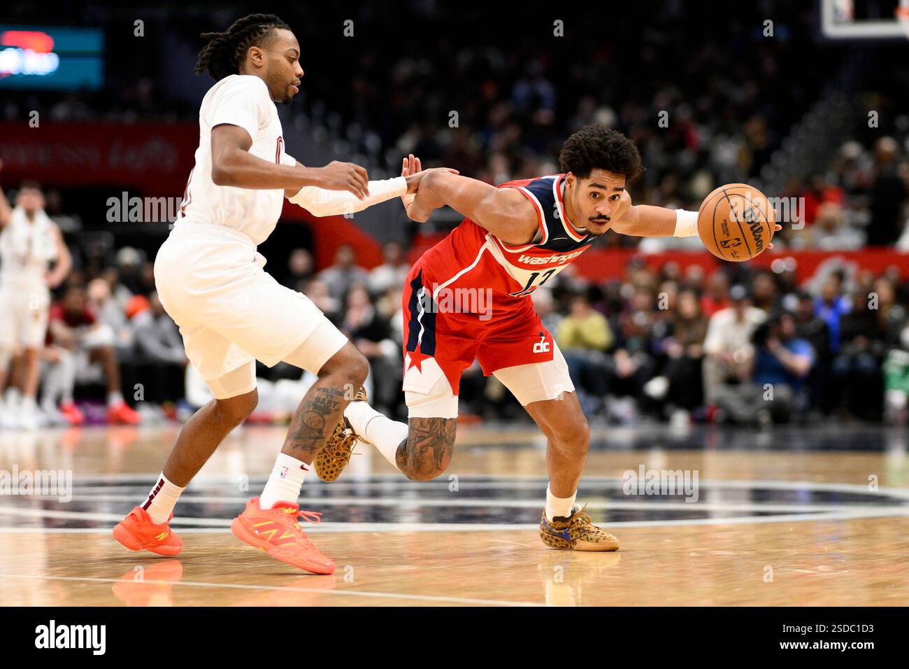 Washington Wizards guard Jordan Poole, right, drives to the basket ...