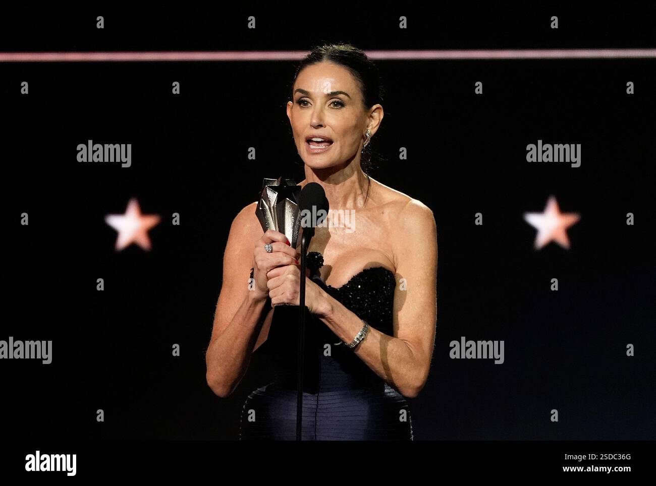 Demi Moore accepts the best actress award for "The Substance" during ...