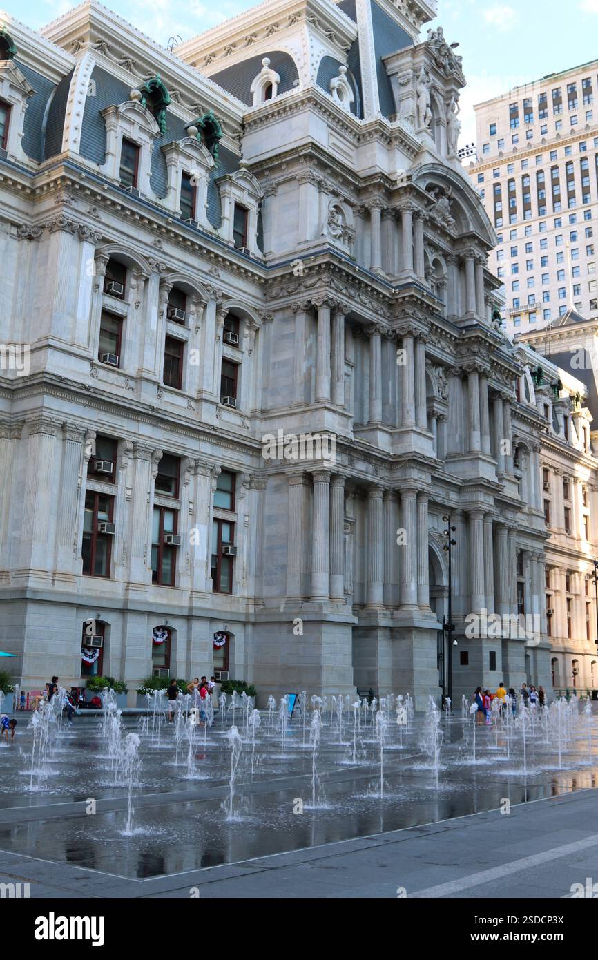 Visitors enjoy splashing water at historic city hall site Stock Photo ...