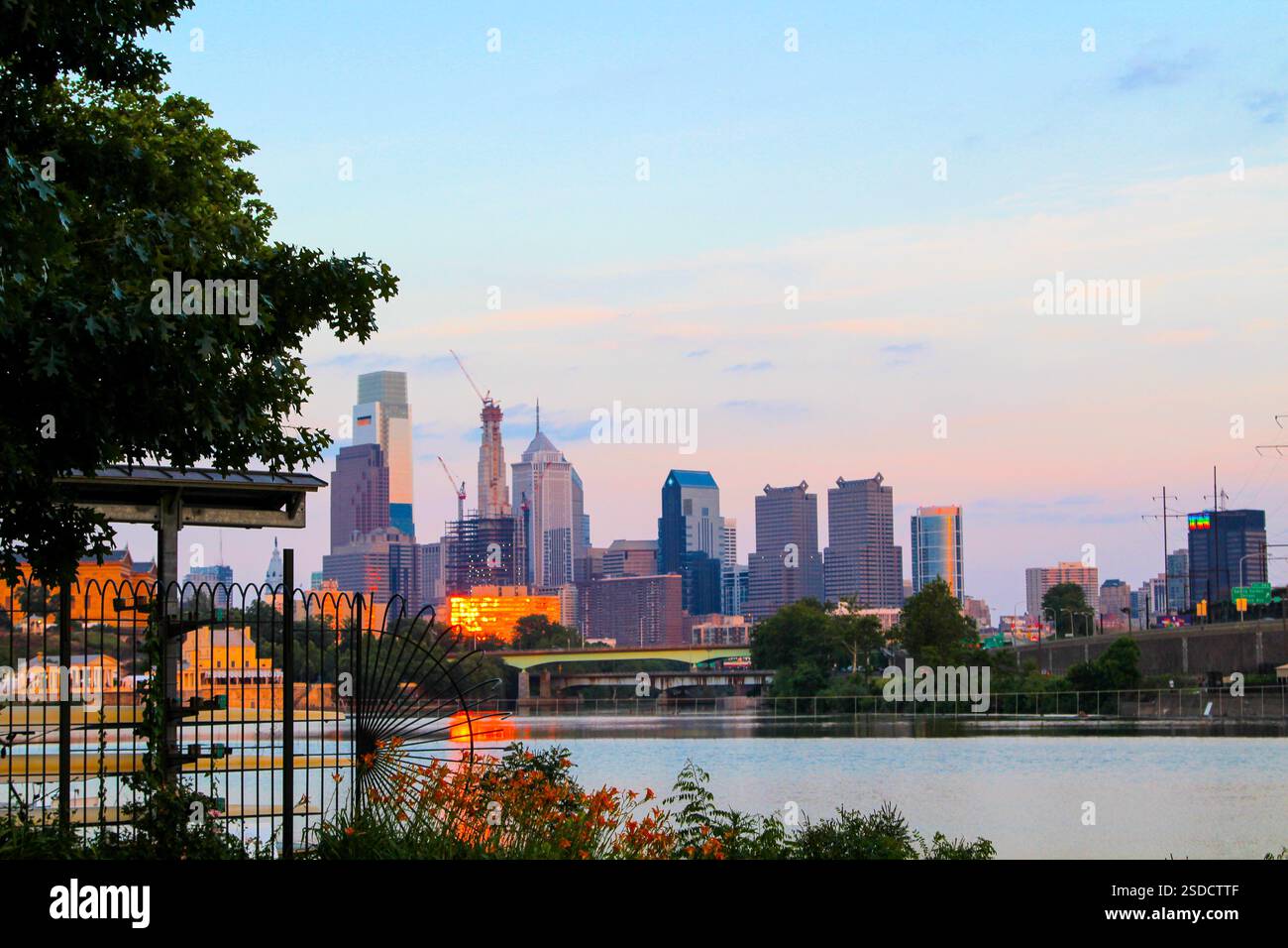 Colorful sunset reflects on water near Philadelphia cityscape Stock ...