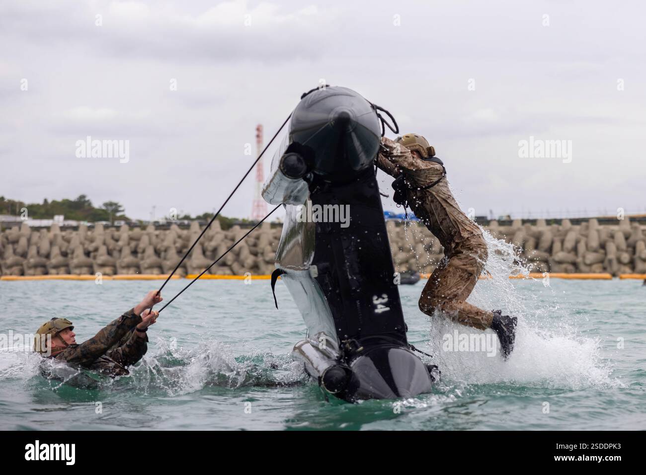 U.S. Marines practice flipping over combat rubber raiding crafts during ...