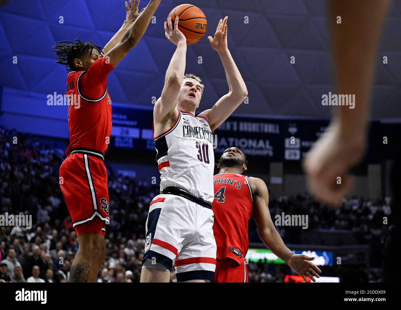 UConn forward Liam McNeeley, center, shoots between St. John's guard ...