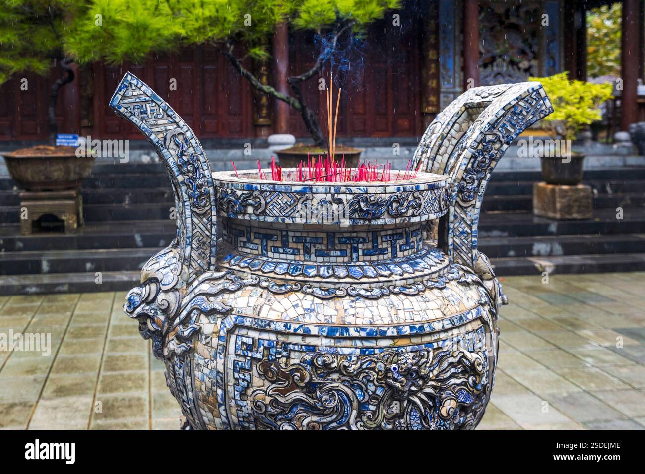 Incense burning in ornate vessel in the courtyard of Tu Hieu Pagoda ...