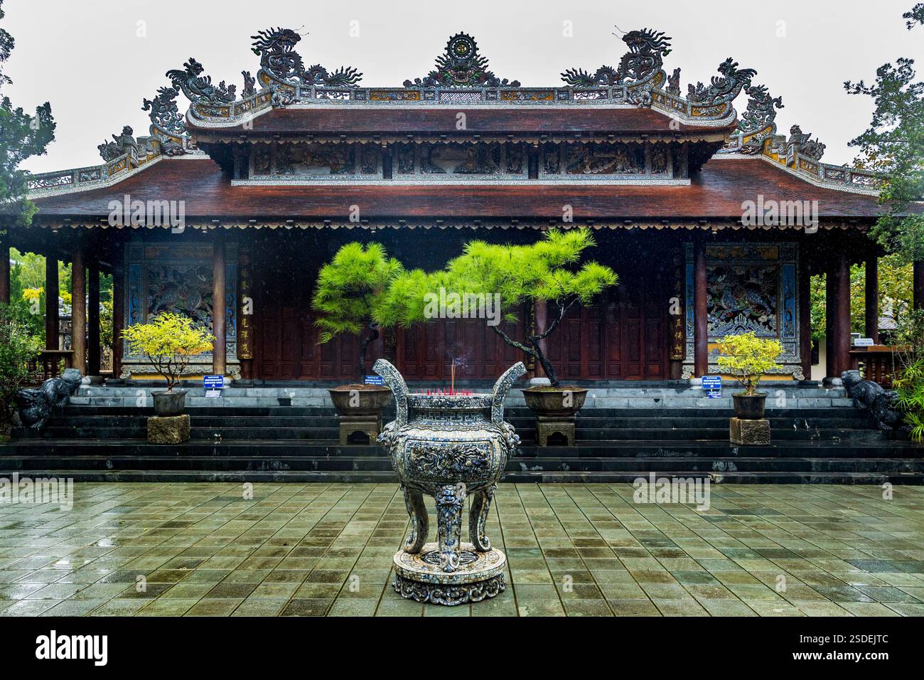 Incense burning in ornate vessel in the courtyard of Tu Hieu Pagoda ...