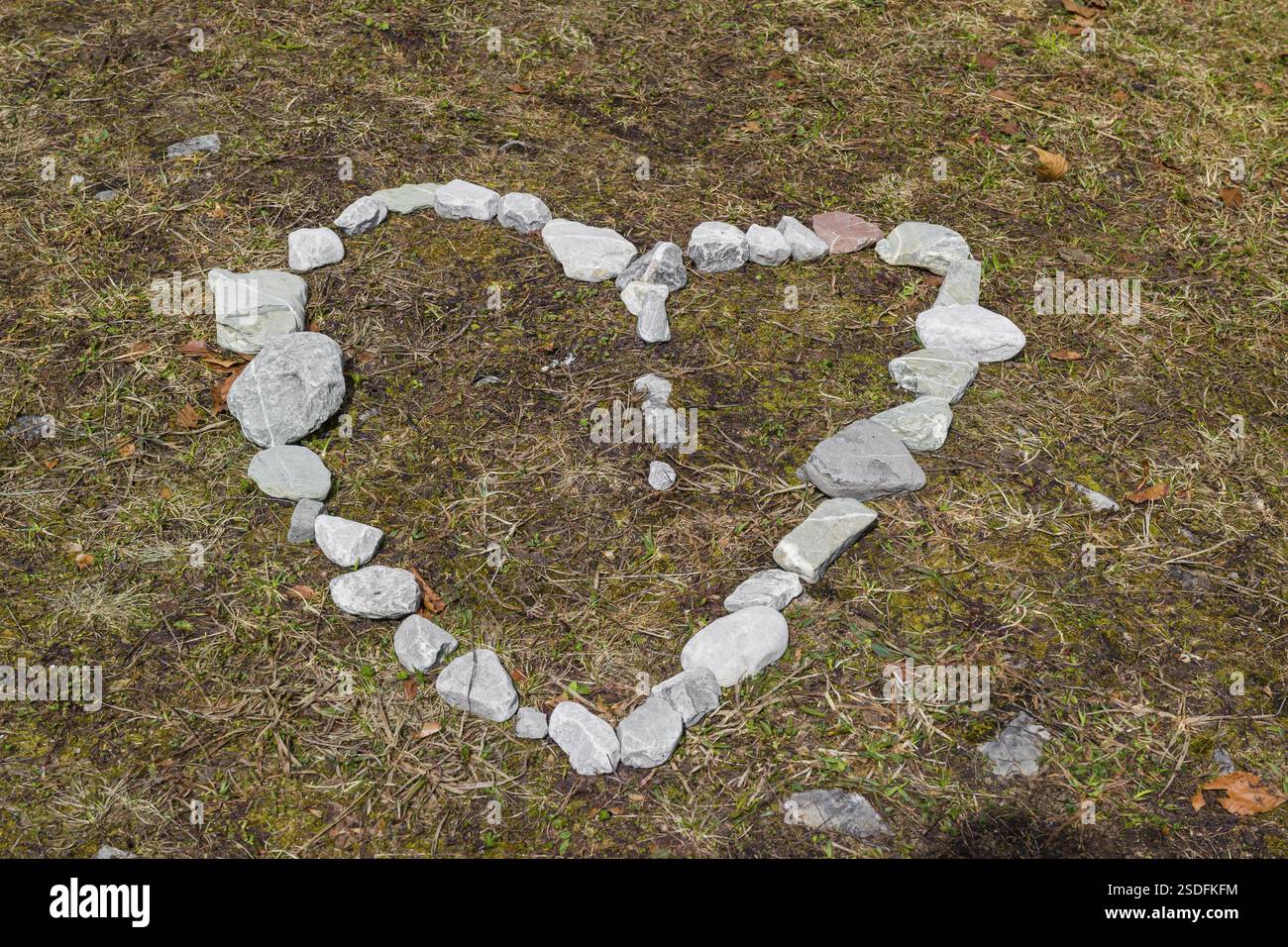 Heart of stone. Pebbles arranged as a heart symbol Stock Photo - Alamy