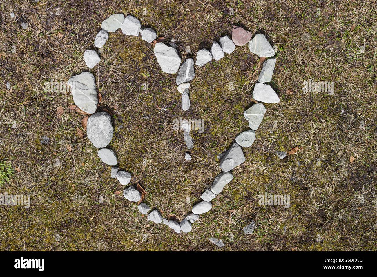 Heart of stone. Pebbles arranged as a heart symbol Stock Photo - Alamy
