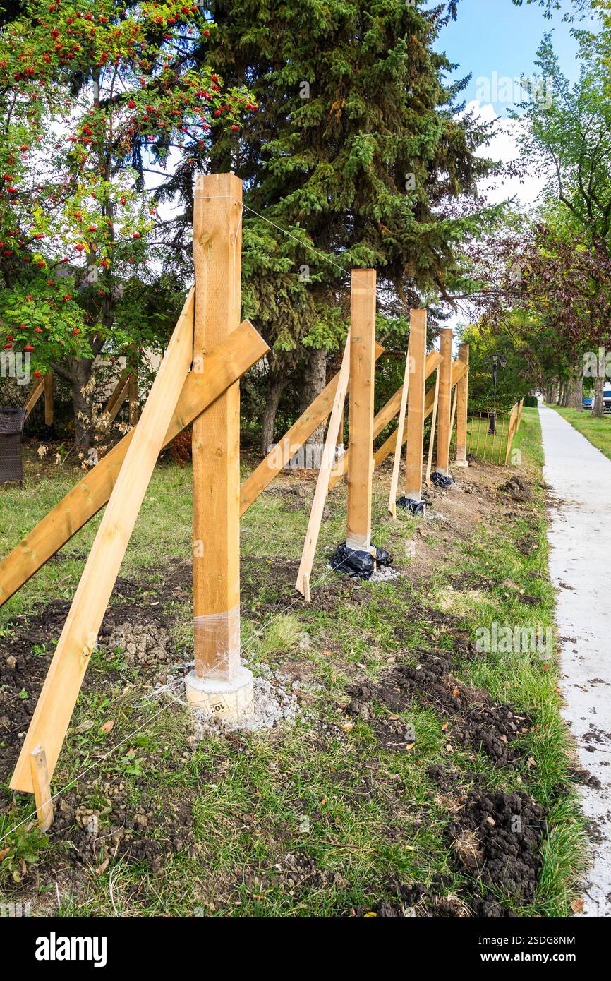 Building fence in progress - setting up poles in concrete base Stock ...