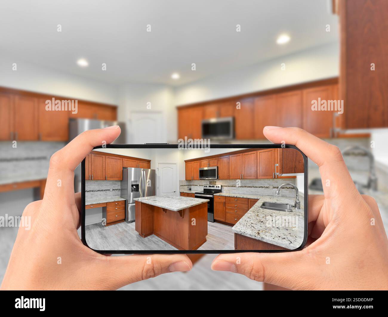 Cell phone taking a picture of a modern residential kitchen interior ...