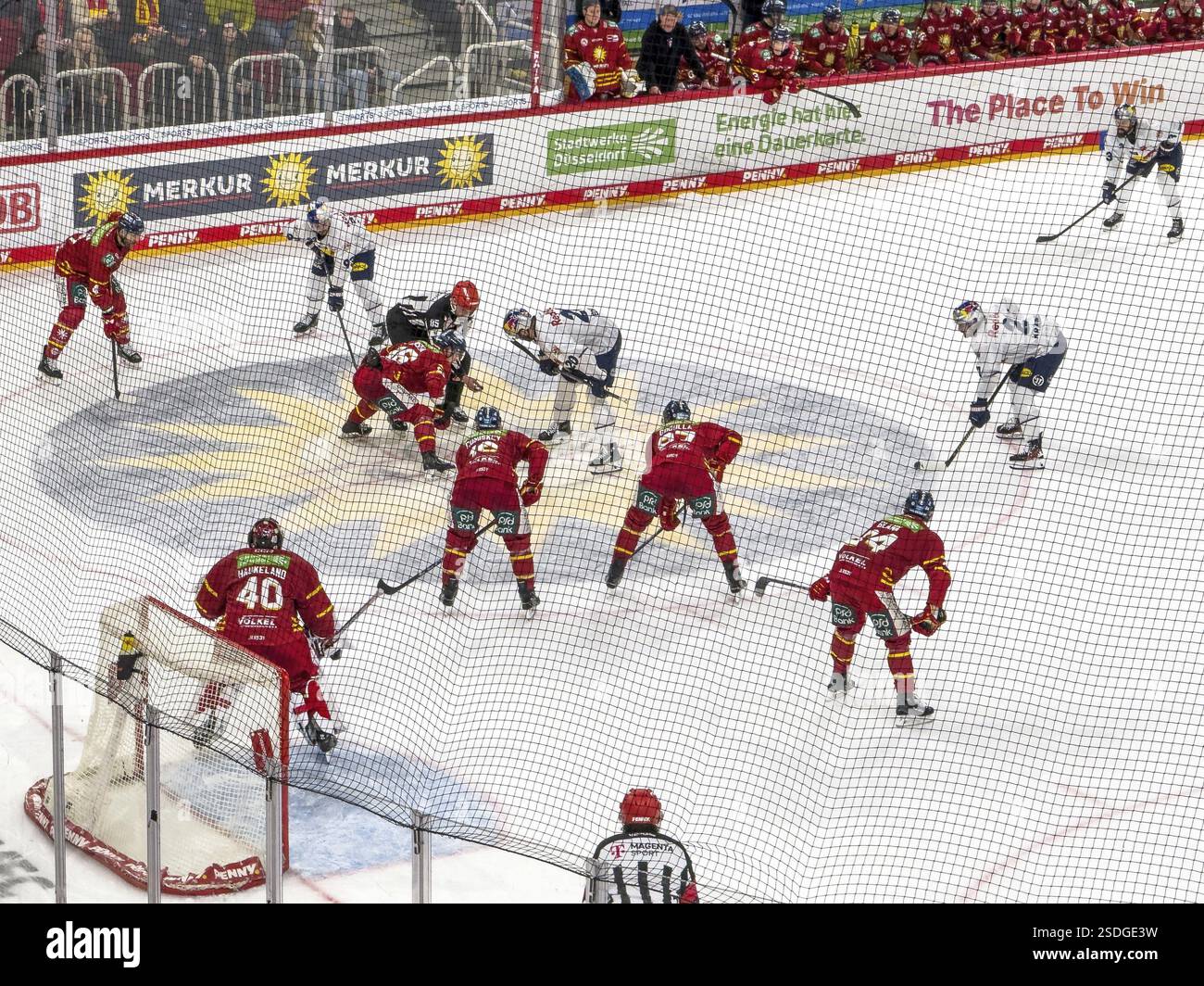 Players and referees in line-up for face-off during ice hockey in ...