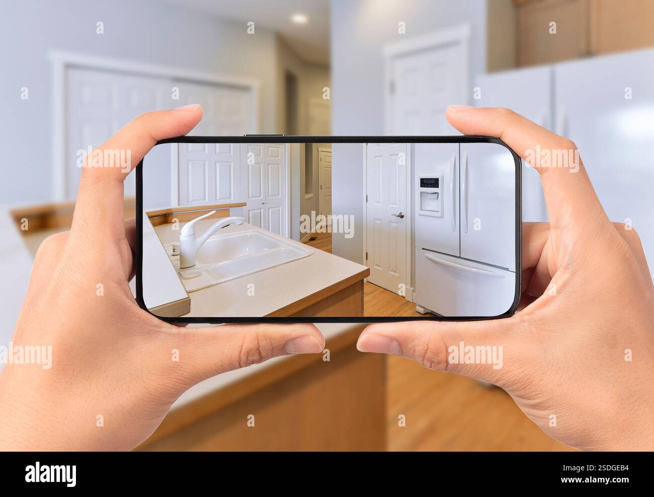 Cell phone taking a picture of a modern residential kitchen interior ...